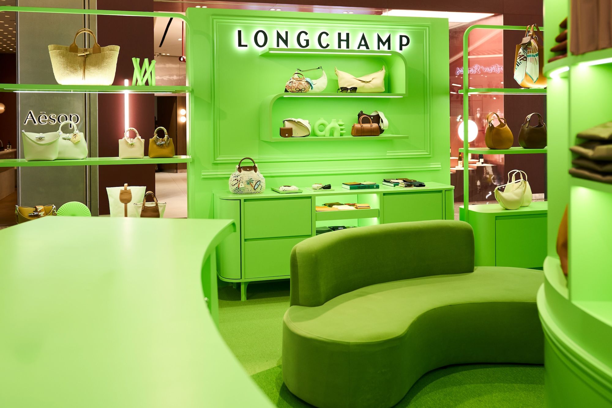 Longchamp debuts a popping green Raffles City store in Singapore